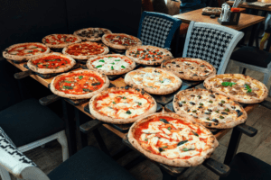 Perfect Math of Ordering Pizzas for 50 People without Spending Extra